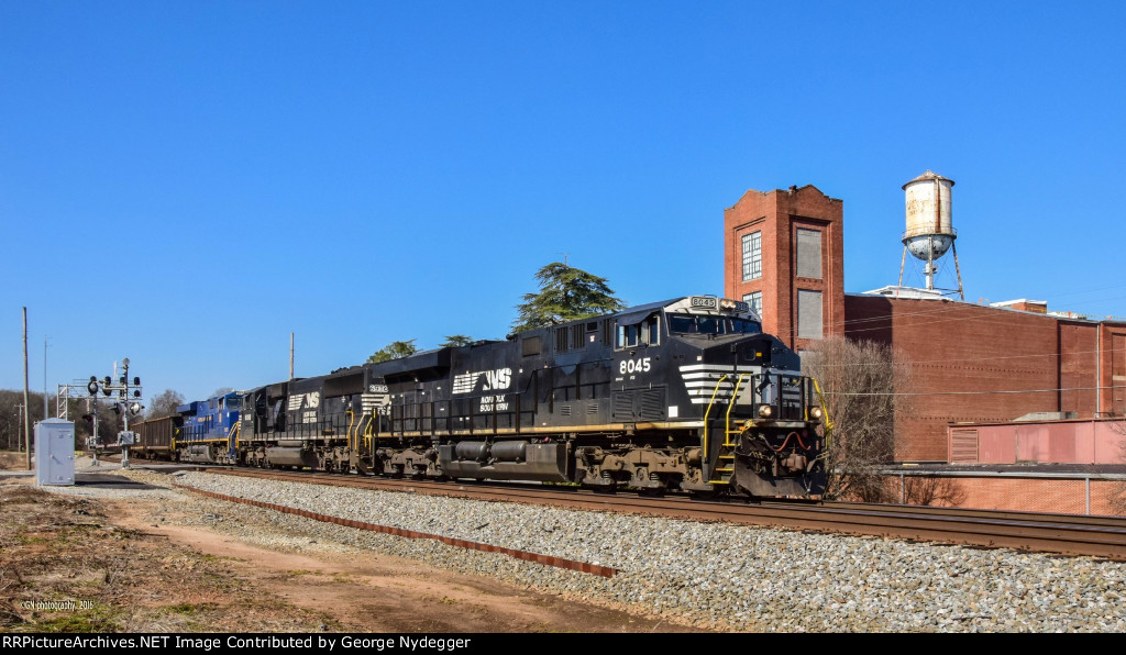 NS 8045 leads a mixed freight by a former textile mill